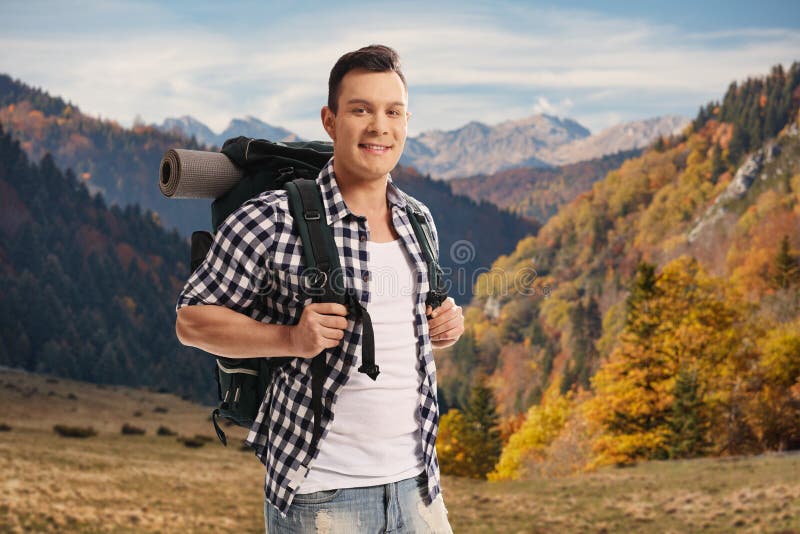 Male Hiker with a Backpack Posing on a Mountain Stock Photo - Image of ...