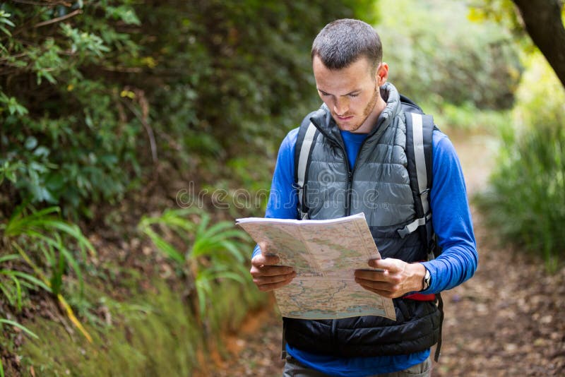 Male hiker looking at map stock image. Image of guidance - 78649897