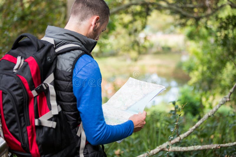 Male hiker looking at map stock photo. Image of hiker - 78649932