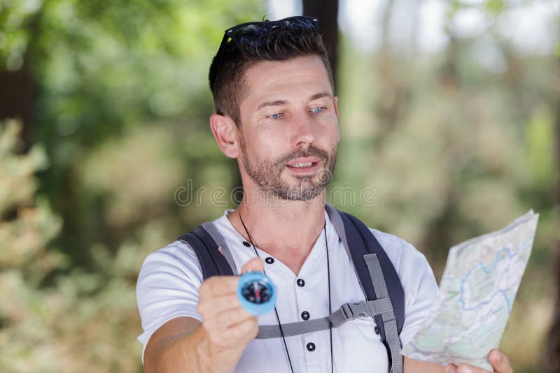 Male Hiker Reading Map and Holding Compass Stock Image - Image of hand ...