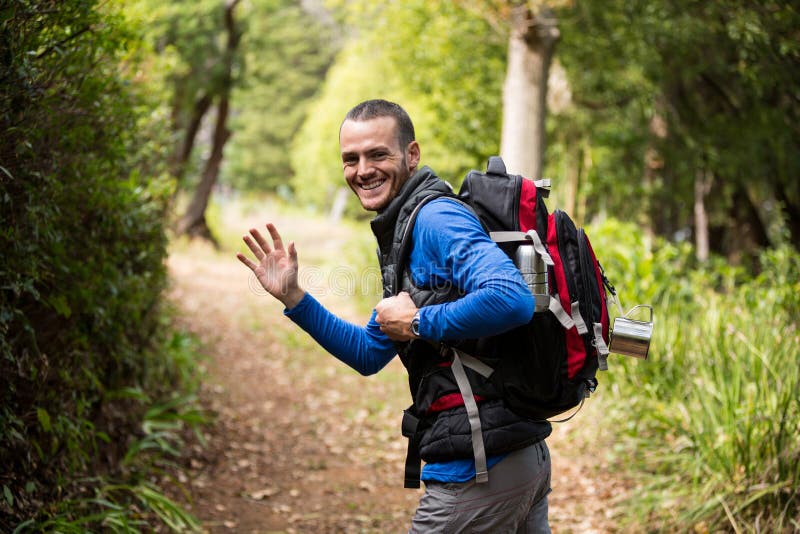 Male Hiker Waving Hand while Walking in Forest Stock Image - Image of ...