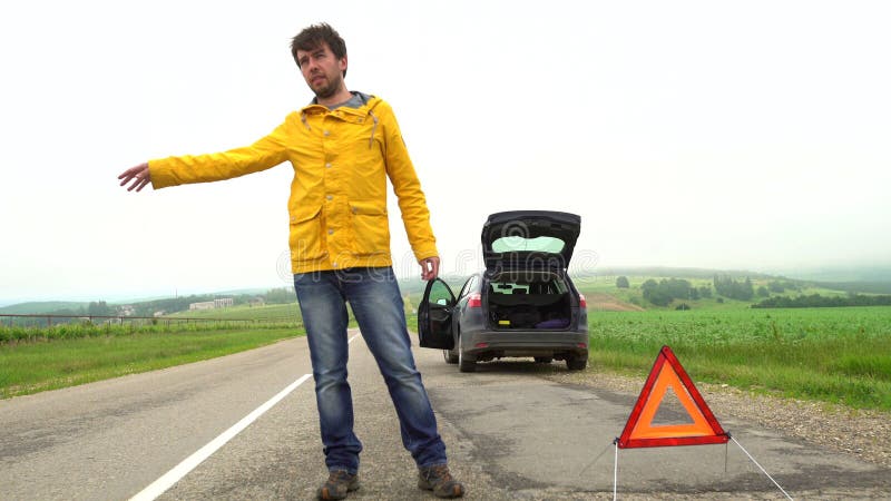 Male with His Broken Down Car with Hazard Lights Put Emergency Marker ...