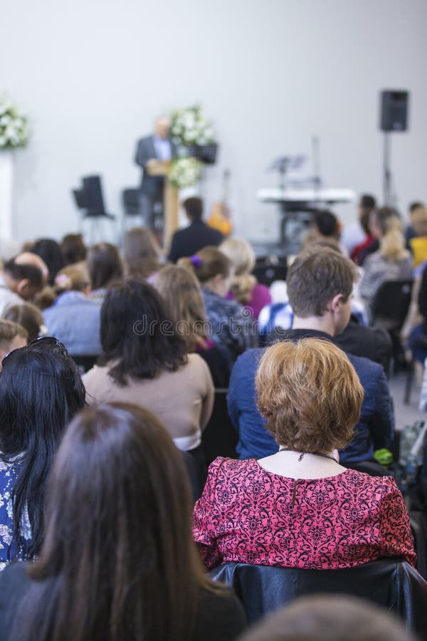 Male Host Speaking on Stage in Front of Group of Professionals ...