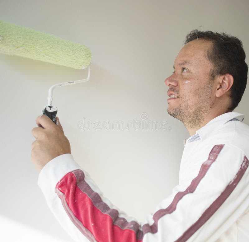 Male House Painter Worker Painting and Priming Wall with Painting ...