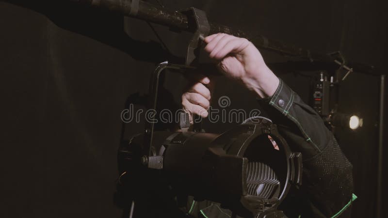 The Male Illuminator Pulls Out the Cable and Removes the Profile Spotlight from the Stand Stock ...