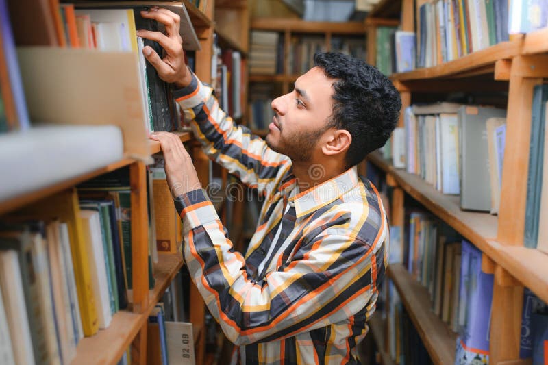 Male Indian Student at the Library with Book Stock Photo - Image of ...