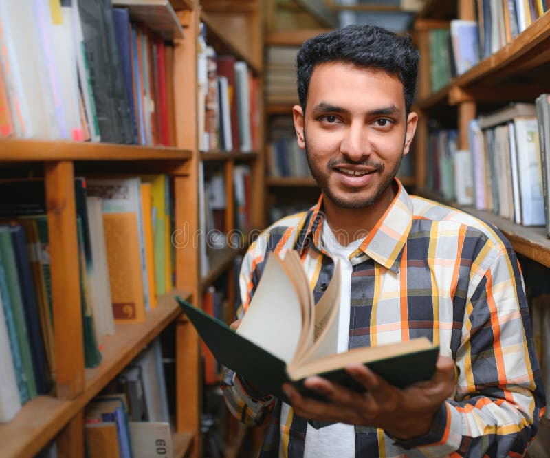 Male Indian Student at the Library with Book Stock Image - Image of ...