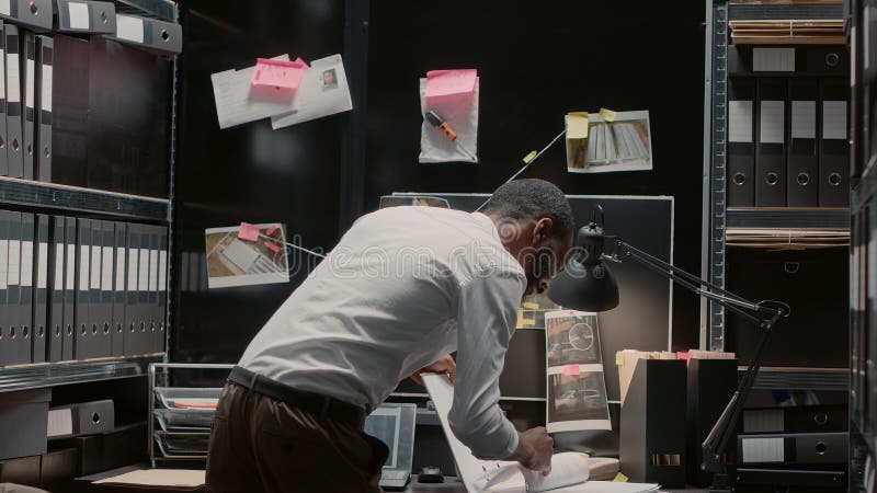 Male Inspector Examining Forensic Evidence on Map Stock Image - Image ...