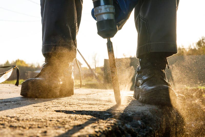 A Male Installer Works with a Hammer Drill. Construction Works. Stock ...