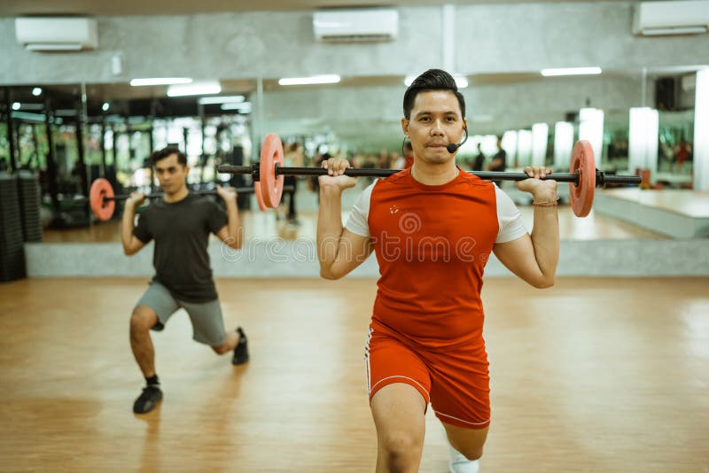 Male Instructor Doing Back Squats with a Barbell during Stock Photo ...