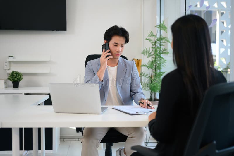 Male Interviewer Having Phone Conversation during a Job Interview ...