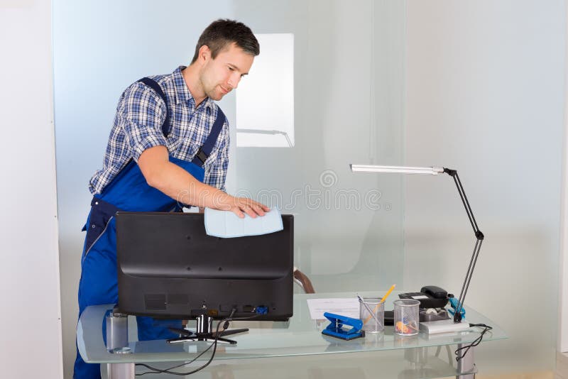 Male Janitor Cleaning Computer in Office Stock Photo - Image of manual ...
