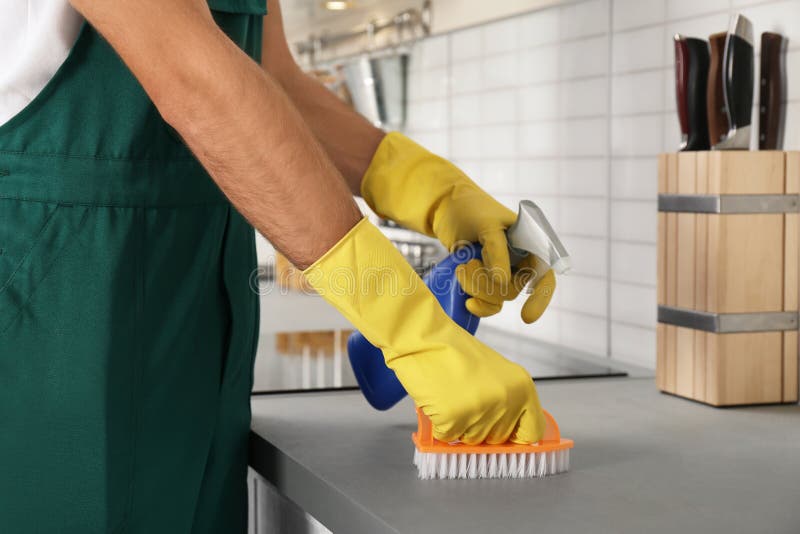 Male Janitor Cleaning Kitchen Counter with Brush Stock Image - Image of ...