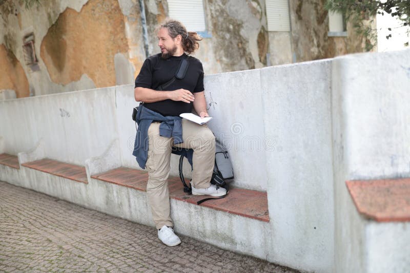 Journalist Taking Notes while Sitting on a Bench Outdoors Stock Image ...