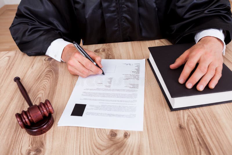 Judge Signing Document At Table In Courtroom Stock Image - Image of ...