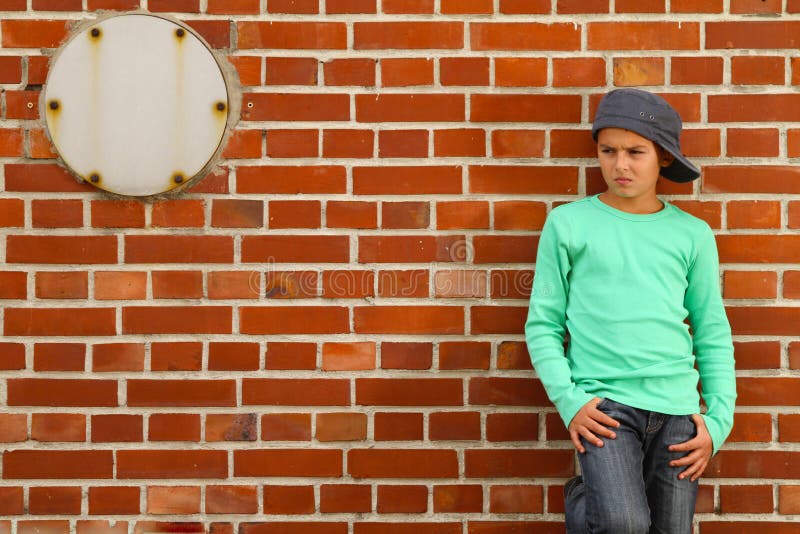 Male Kid Standing on a Brick Stone Wall Stock Image - Image of shirt ...