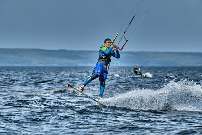 A Male Kiter Slides on the Surface of the Water. Stock Image - Image of ...