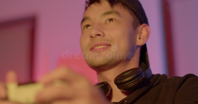 A a Male of Korean is Using a Video Game Controller. he Controls the ... A a Male of Korean is Using a Video Game Controller. he Controls the ...