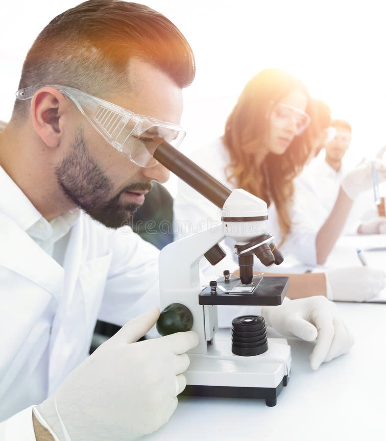 Male Lab Technician Looks at the Sample Under a Microscope Stock Image ...