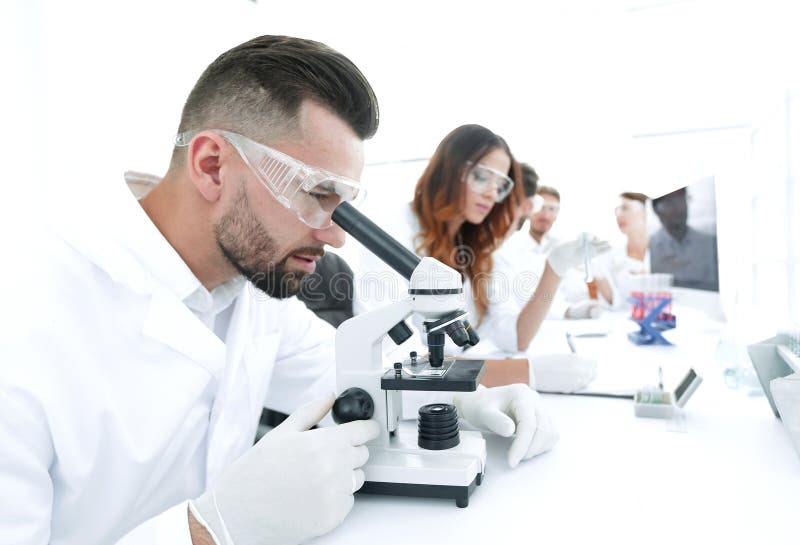 Male Lab Technician Looks at the Sample Under a Microscope Stock Photo ...