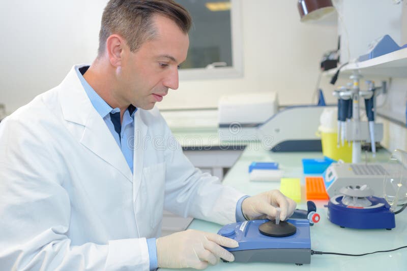 Male Laboratory Technician Looking at Samples in the Microscope Stock ...