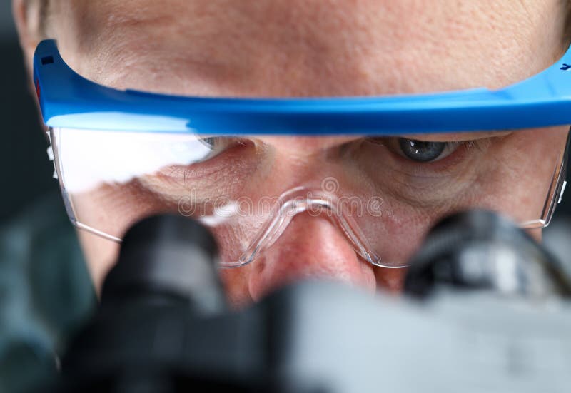 Male Laboratory Technician Looking at Samples in the Microscope Stock ...