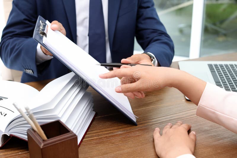 Male Lawyer Working with Client at Table Stock Image - Image of ...