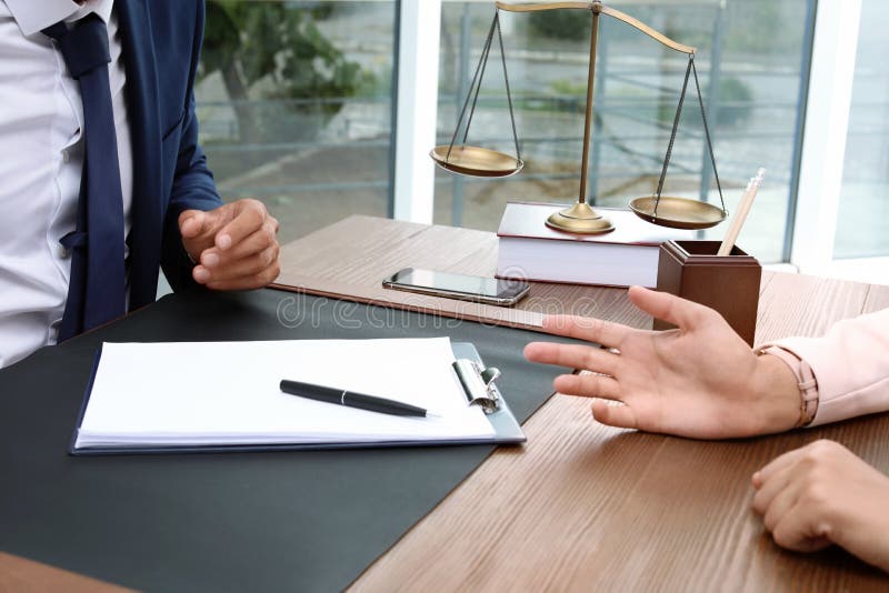 Male Lawyer Working with Client at Table Stock Image - Image of ...