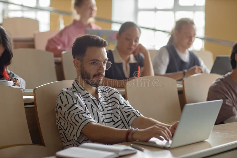Male Learner Writing Lecture on Computer at College Stock Photo - Image ...