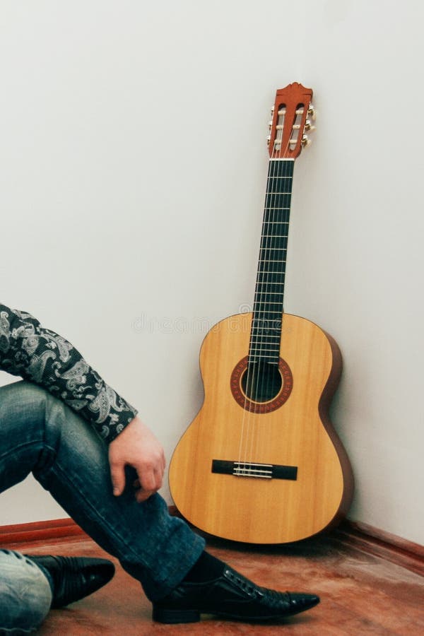 Male legs in and guitar stock photo. Image of pants - 138654574
