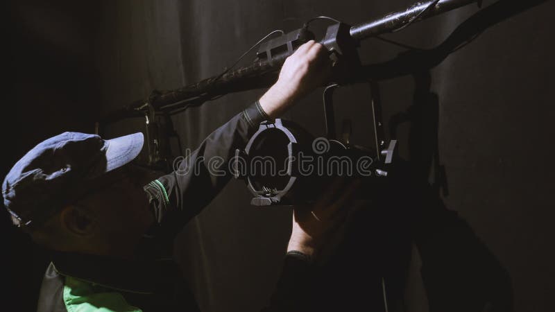 A Male Lighting Engineer Hangs a Profile Spotlight on a Tripod Stock ...