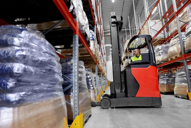 Male Loader Operating Forklift at Warehouse Stock Photo - Image of ...