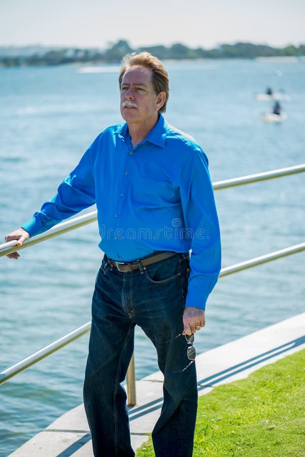 Male looking out on water stock photo. Image of background - 60407590