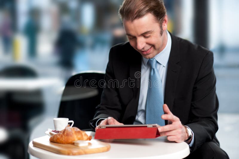 Male Manager Browsing Internet on Tablet Device Stock Photo - Image of ...