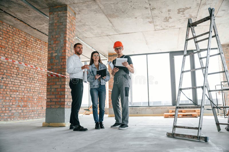 Male Manager, Foreman and Woman is Together on the Construction Site ...