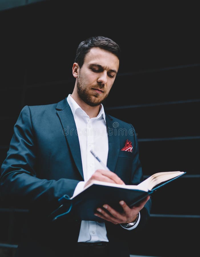 Male Manager in Formal Analyzing Schedule with Day Planner at City ...