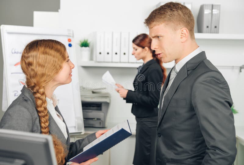 Male Manager Instructs Female Employee in Office Stock Photo - Image of ...