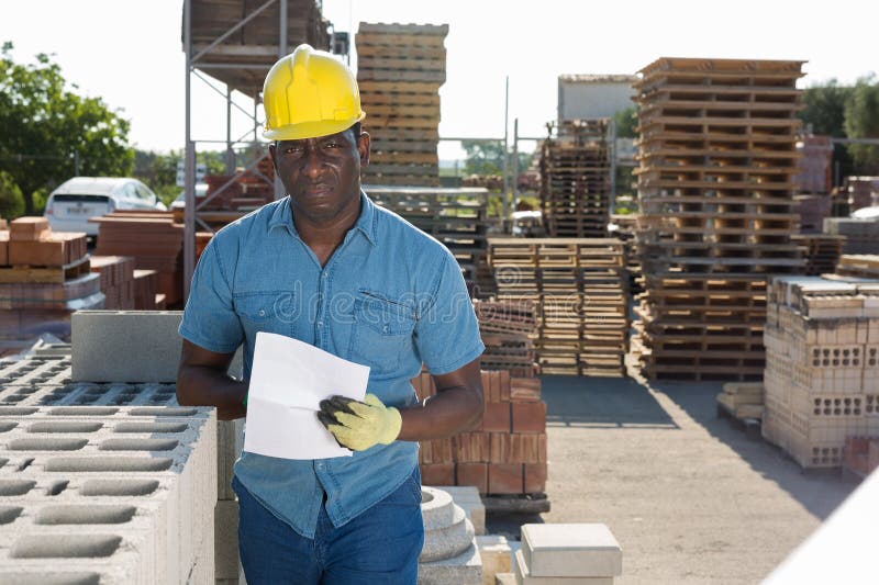 Male Manager Keeps Records of Bricks in Open Area of Hardware Store ...