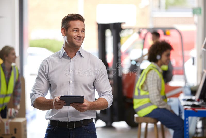 Male Manager in Logistics Distribution Warehouse Using Digital Tablet ...
