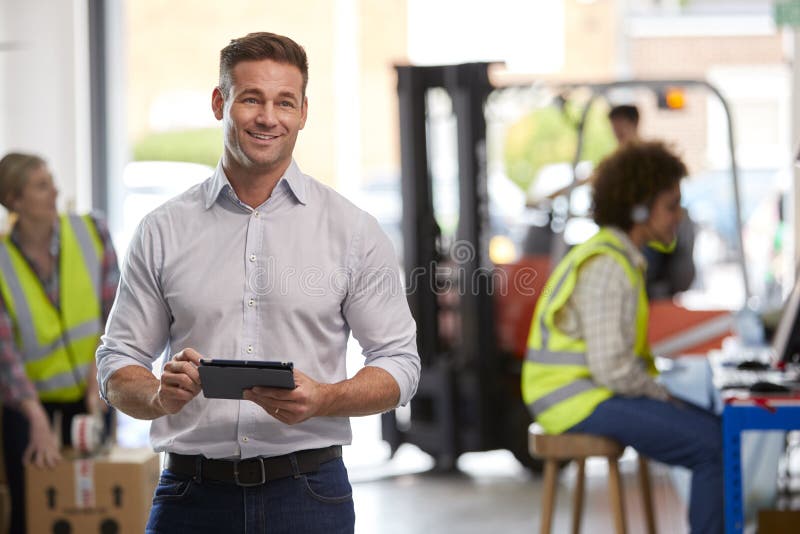 Male Manager in Logistics Distribution Warehouse Using Digital Tablet ...