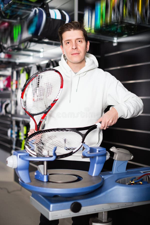 Male Master is Pulling Racket for Tennis in the Store. Stock Image ...