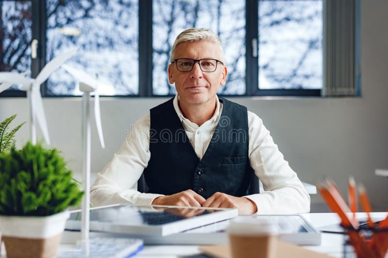 Male Mature Architect Working on an Ecological Construction Project in ... Male Mature Architect Working on an Ecological Construction Project in ...