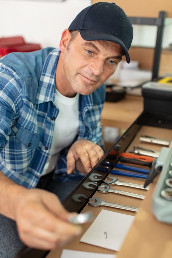 Male Mechanic Choosing Spanner from Drawer in Tool Cabinet Stock Photo ...