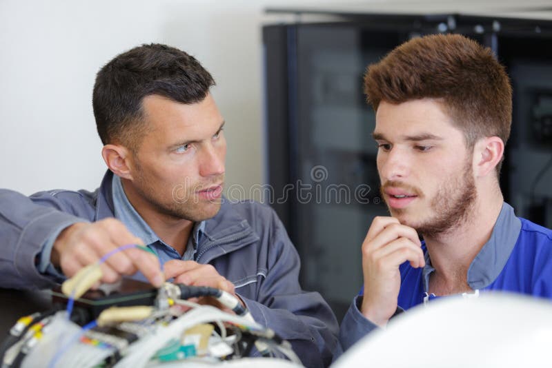 Male Mechanic Training Apprentice Stock Photo - Image of unsure, learn ...