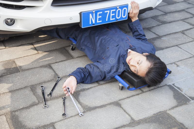 Male Mechanic Working Under the Car Stock Photo - Image of shop, angel ...