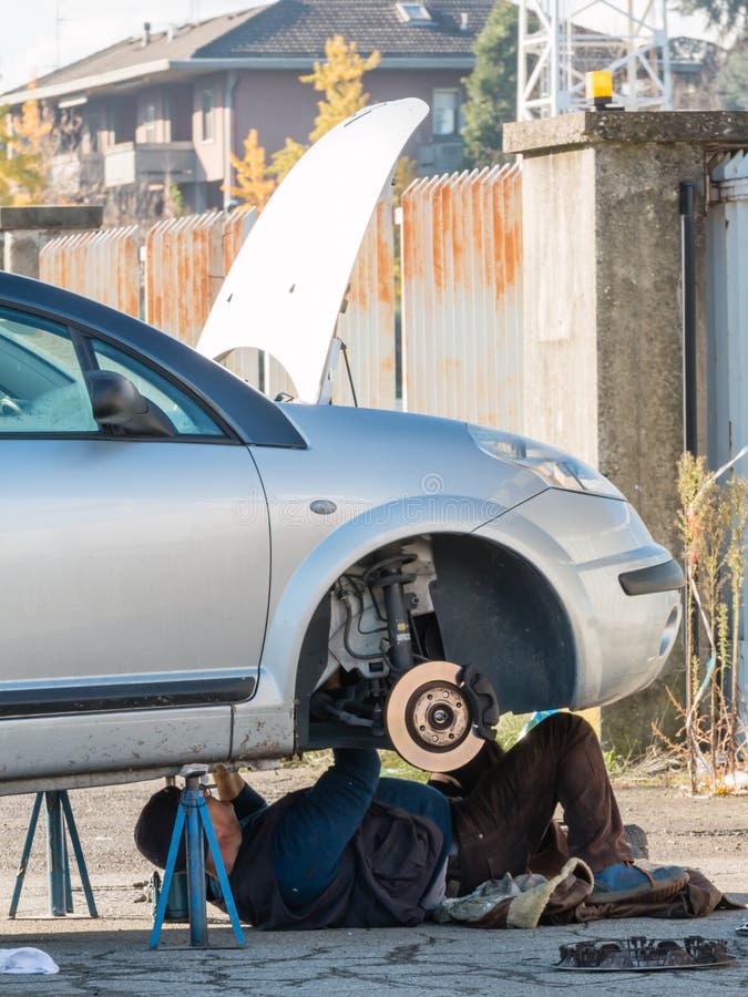 Male Mechanic Working Under Car At A Small Car Service Editorial Stock ...