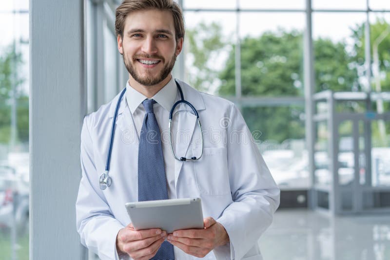 Male Medical Doctor Using Tablet Computer in Hospital. Stock Photo ...