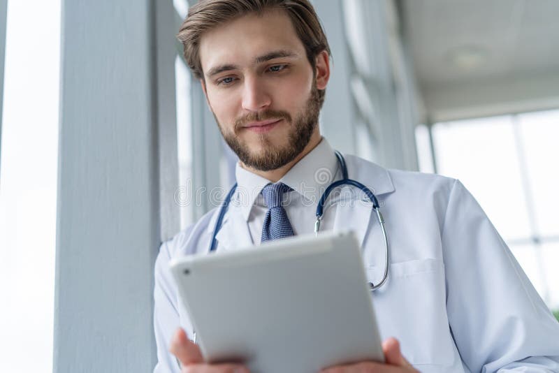 Male Medical Doctor Using Tablet Computer in Hospital. Stock Image ...
