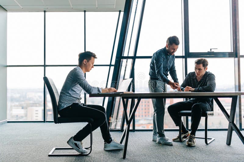 A Male Mentor Offering Guidance To a Trainee on How To Complete a Work ...
