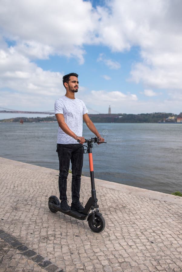 Male Model in Font of River with Scooter Stock Image - Image of city ...